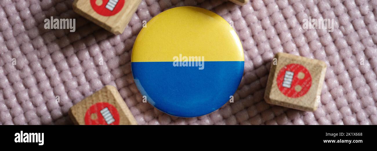 Ukrainian flag sign and cube with evil emoticons around Stock Photo - Alamy