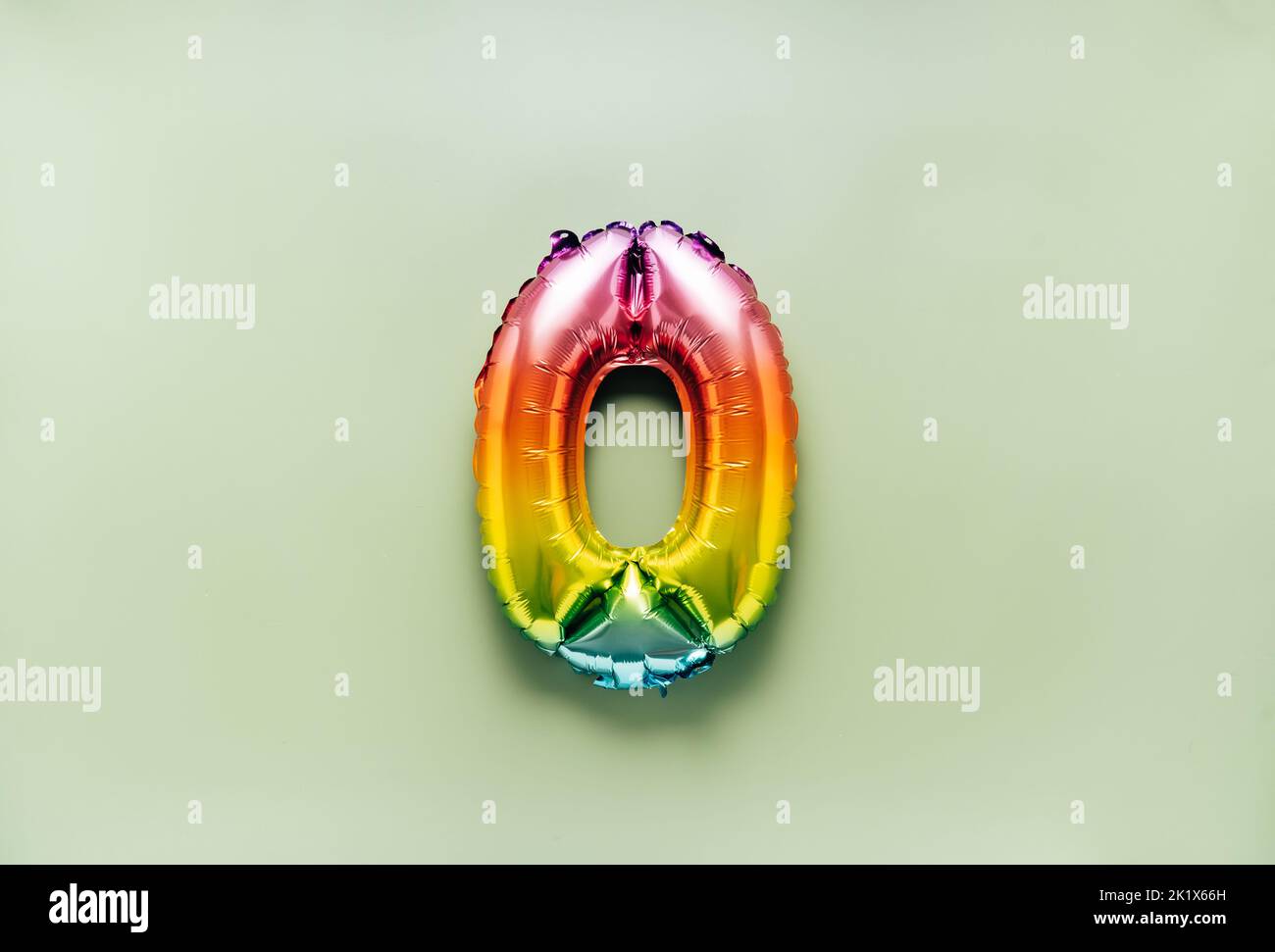 Colorful balloon number 0 on light green background. New Year of ...