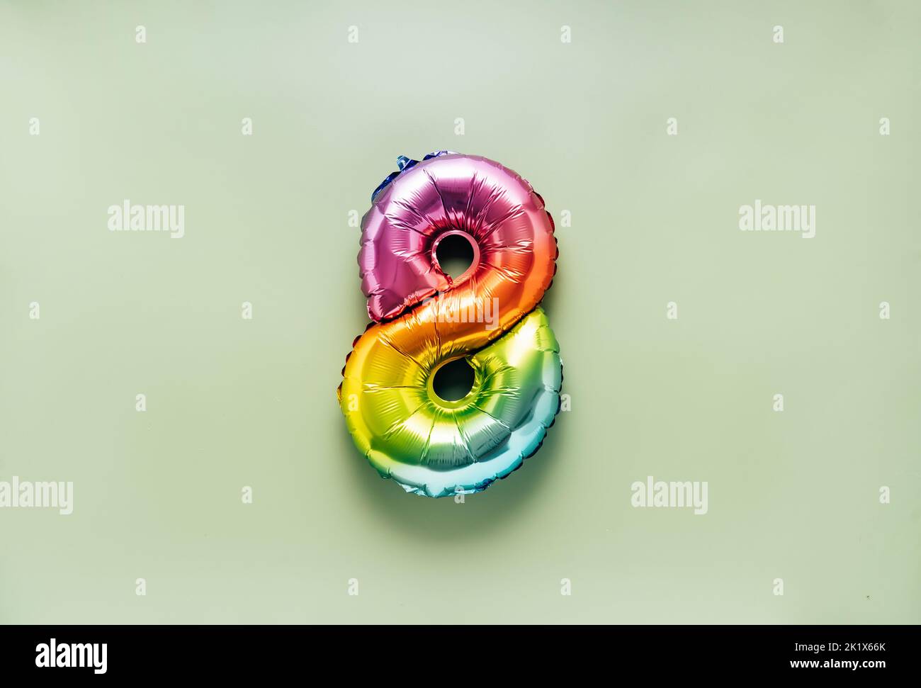Colorful balloon number 8 on light green background. New Year of ...