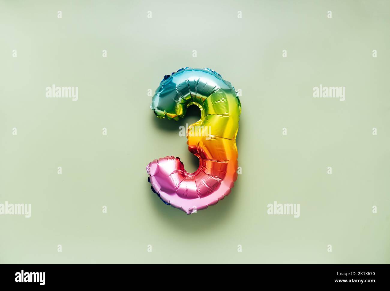 Colorful balloon number 3 on light green background. New Year of ...