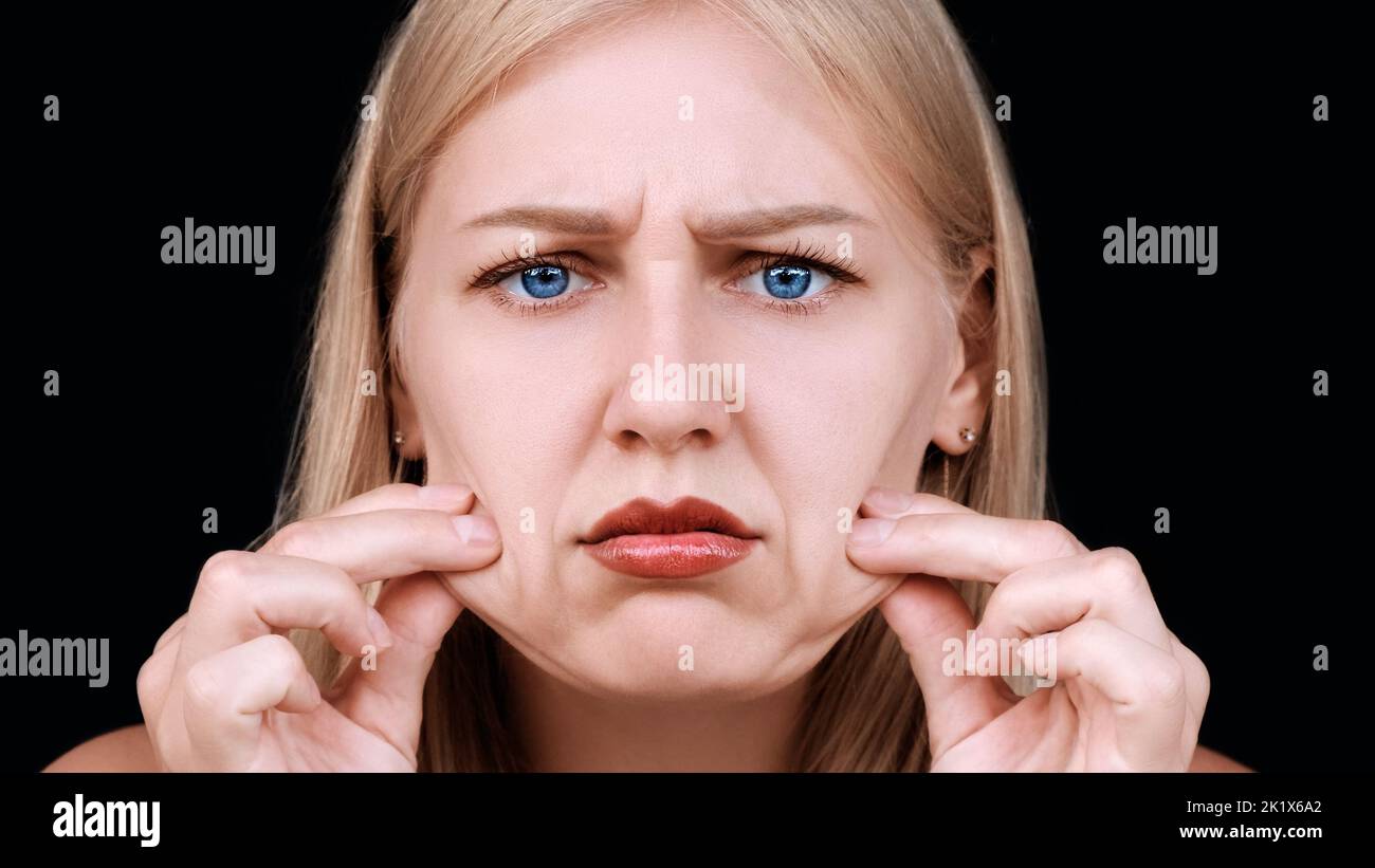 Second chin, obesity. Portrait of a 30-year-old woman pulling back the ...