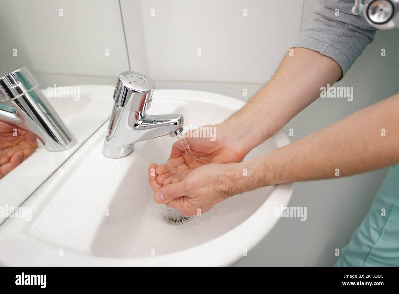 mid section of woman washing hands in the kitchen Stock Photo - Alamy