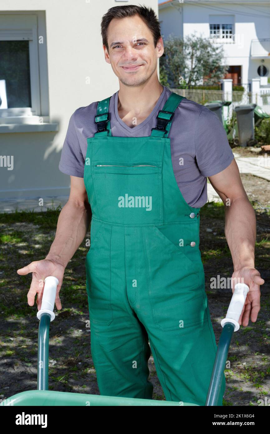 male gardener using a wheelbarrow Stock Photo - Alamy