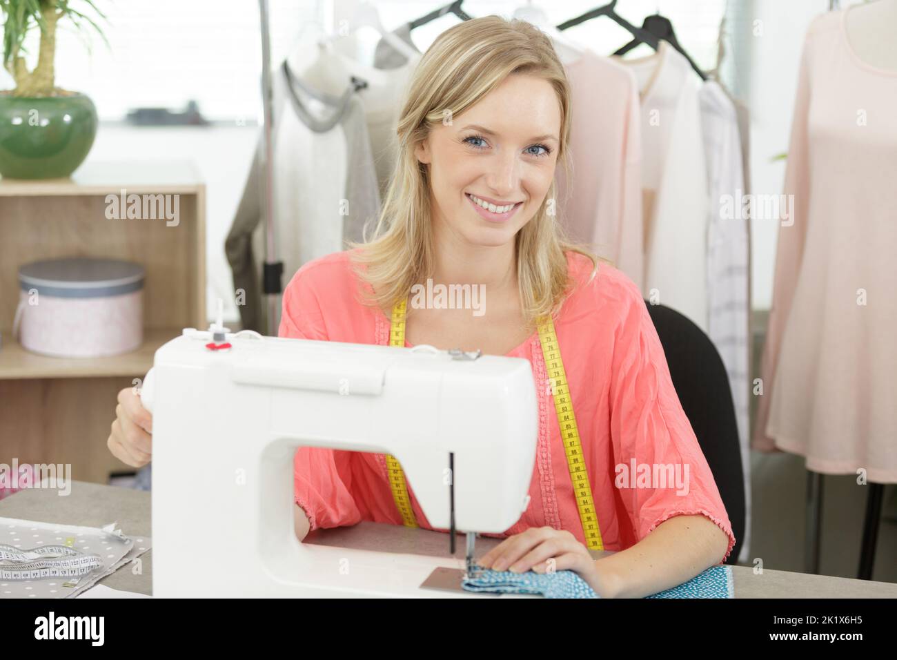 portrait of female dressmaker using sewing machine Stock Photo - Alamy