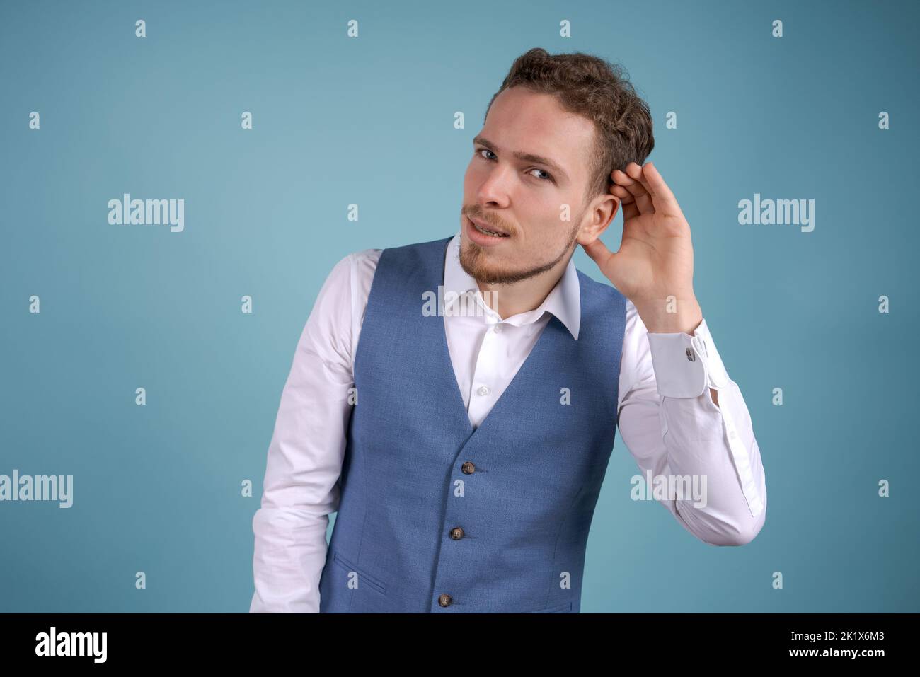 What does not hear you. Handsome business guy in white shirt and blue ...