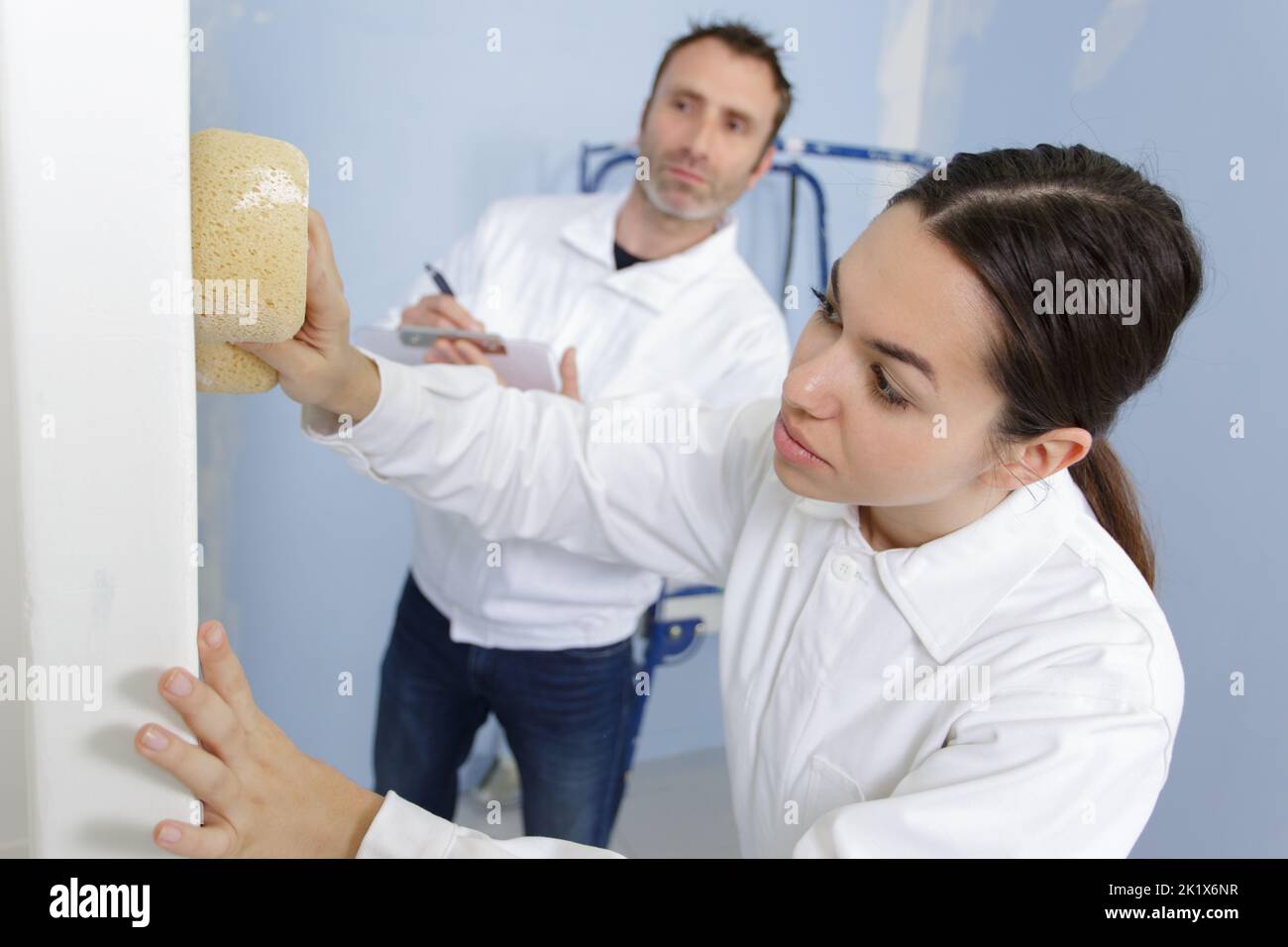 a painter with a female apprentice Stock Photo - Alamy