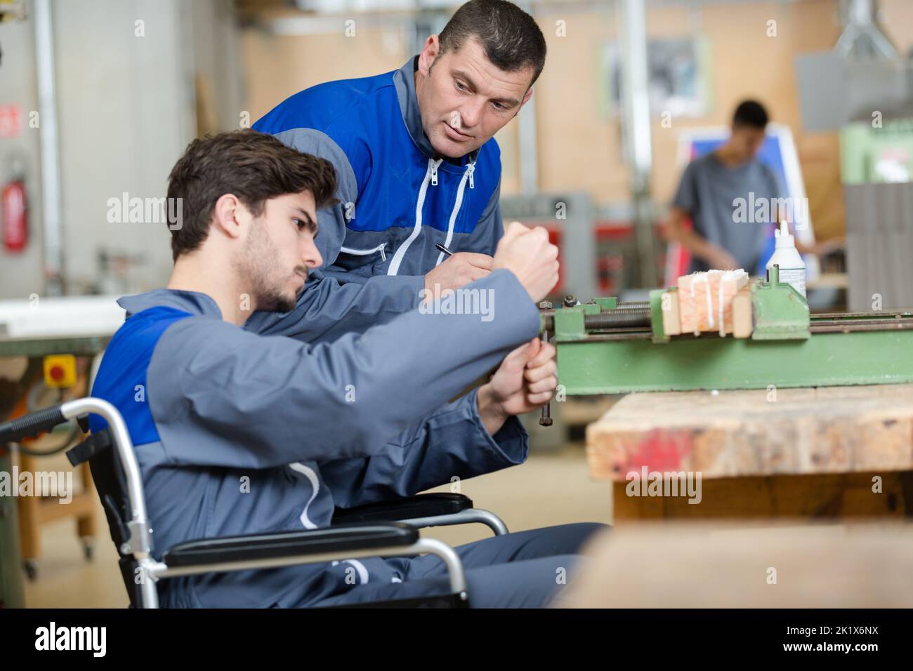 disabled worker in wheelchair with colleague Stock Photo - Alamy