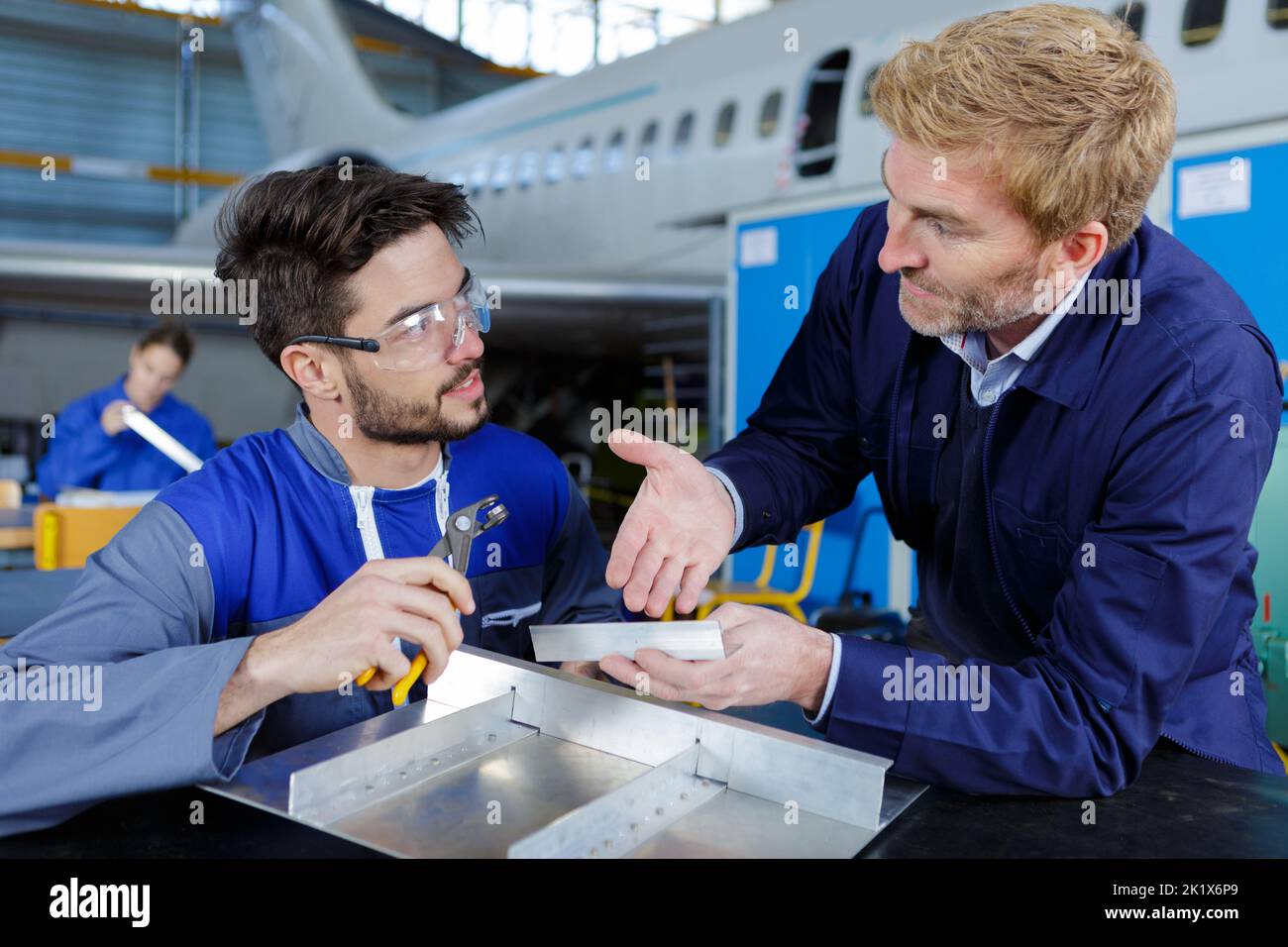 portrait of men working on airplane engine Stock Photo - Alamy