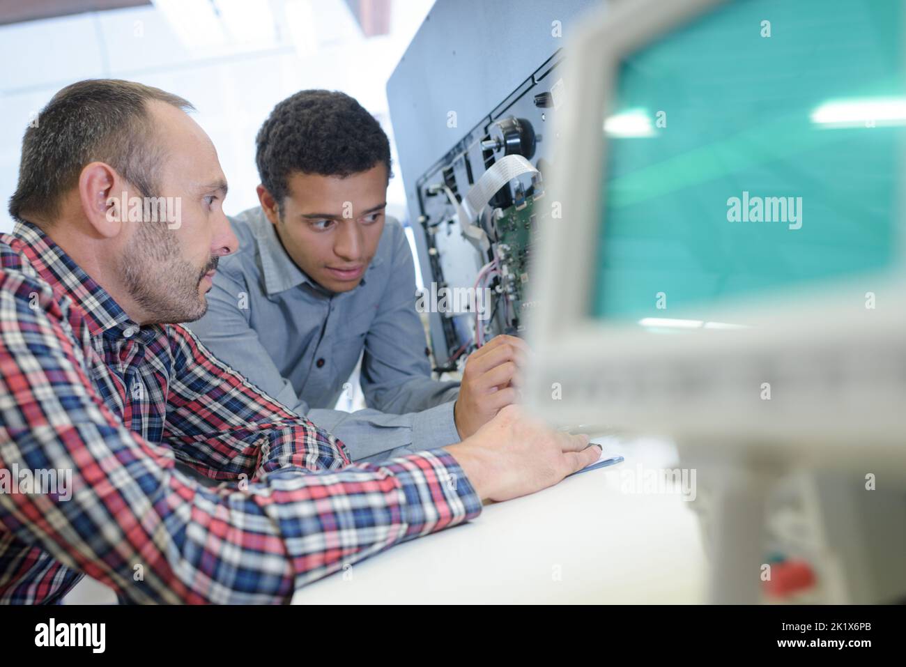 two technicians working on electronic system Stock Photo - Alamy