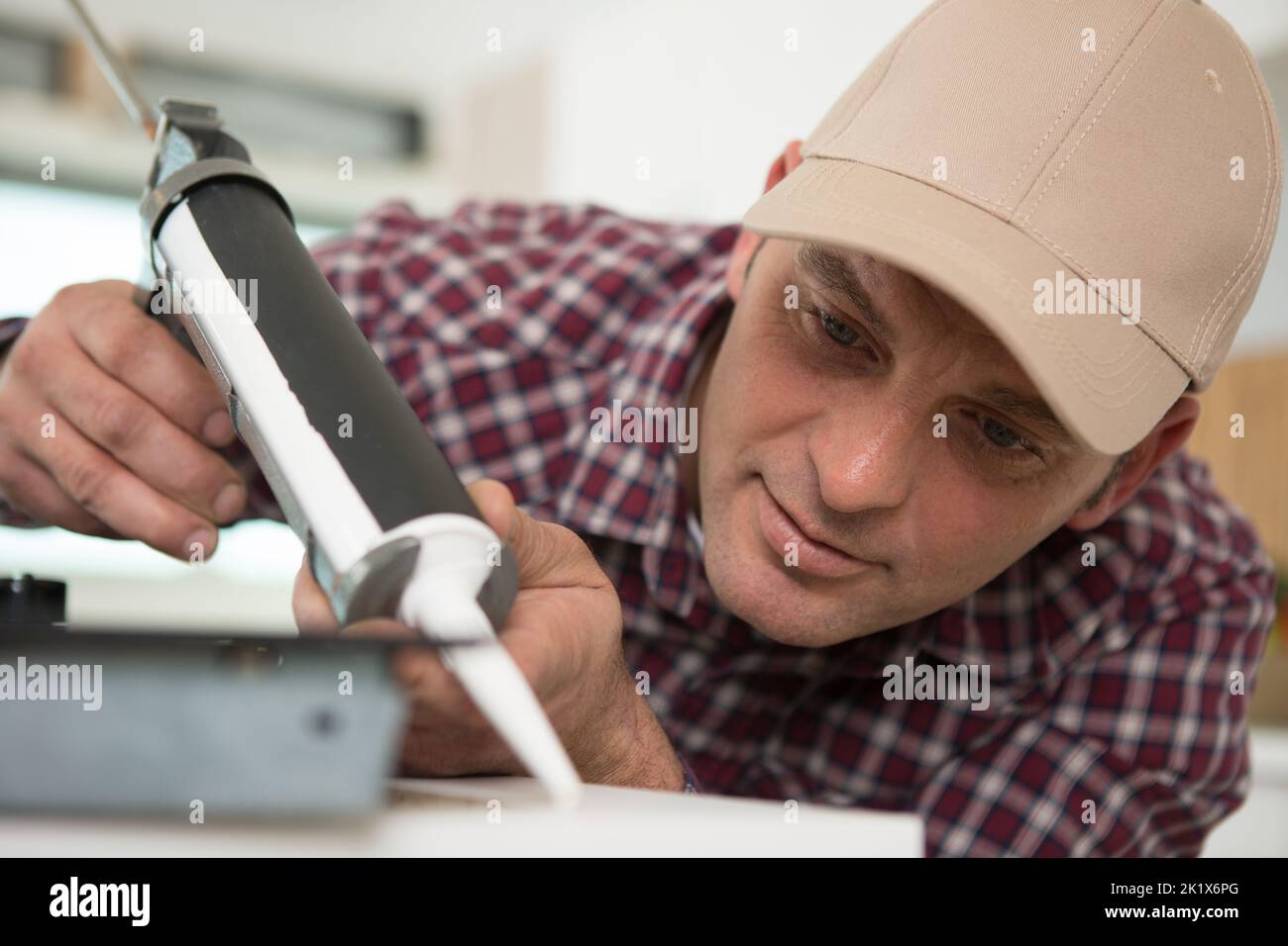 male worker with silicone sealant Stock Photo - Alamy