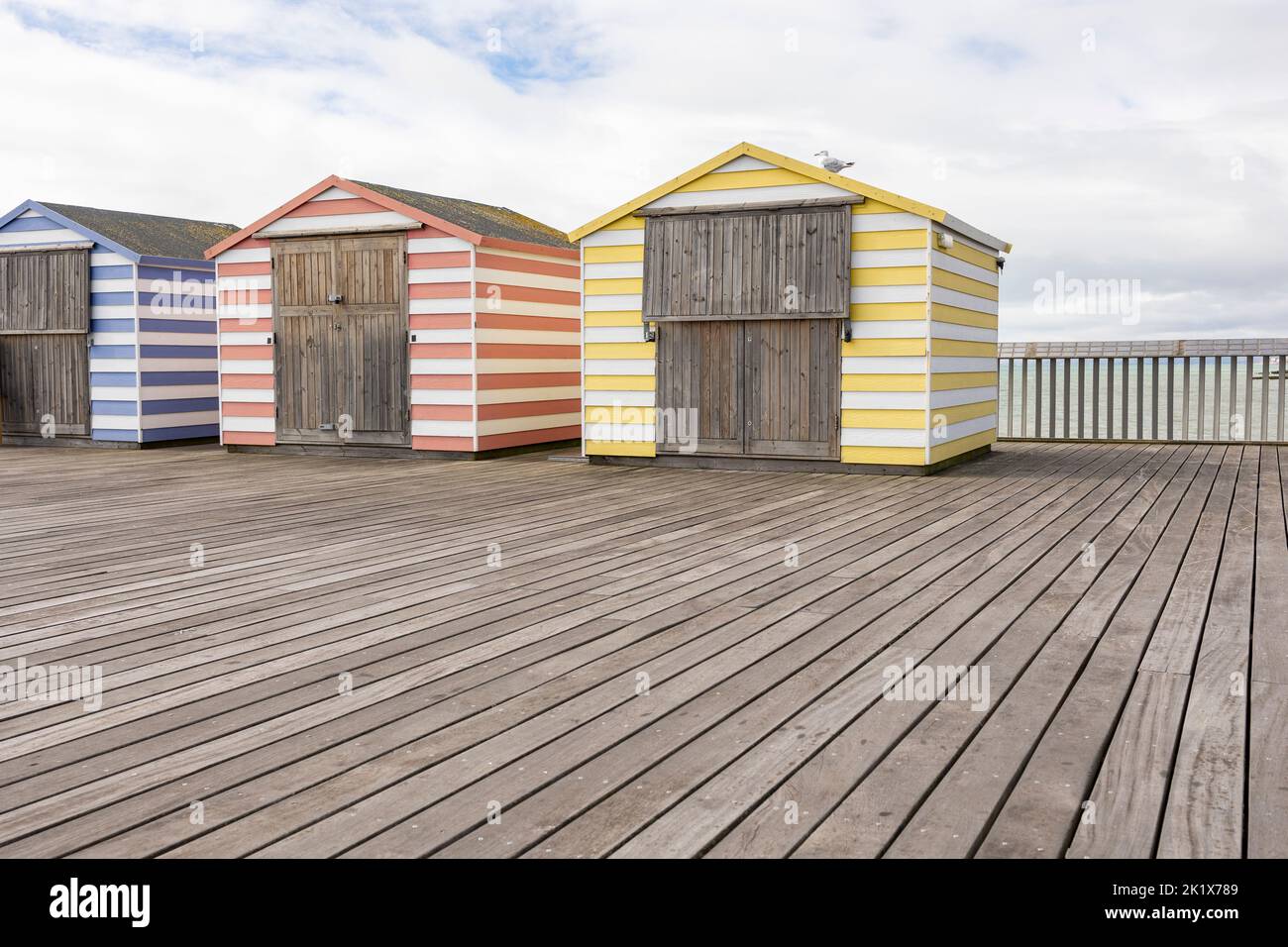colourfull pier huts on hastings pier, copy space Stock Photo - Alamy