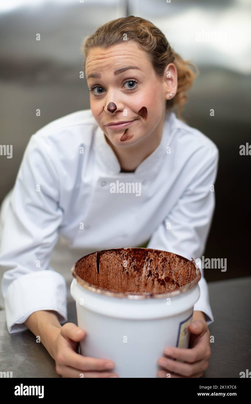 female chef which chocolate on her face Stock Photo - Alamy