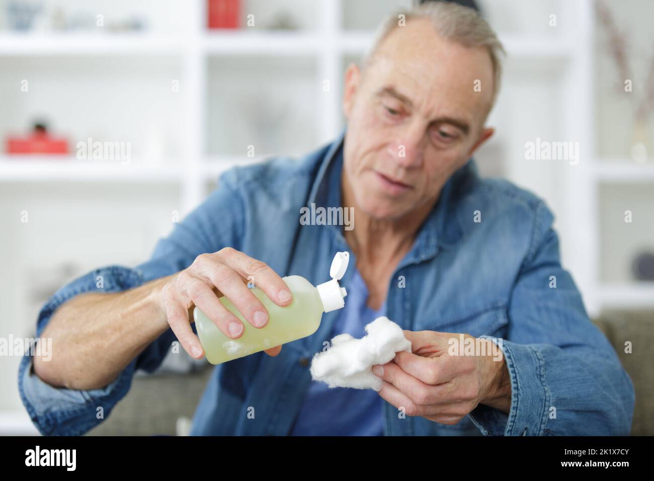 senior holds alcohol and cotton Stock Photo - Alamy