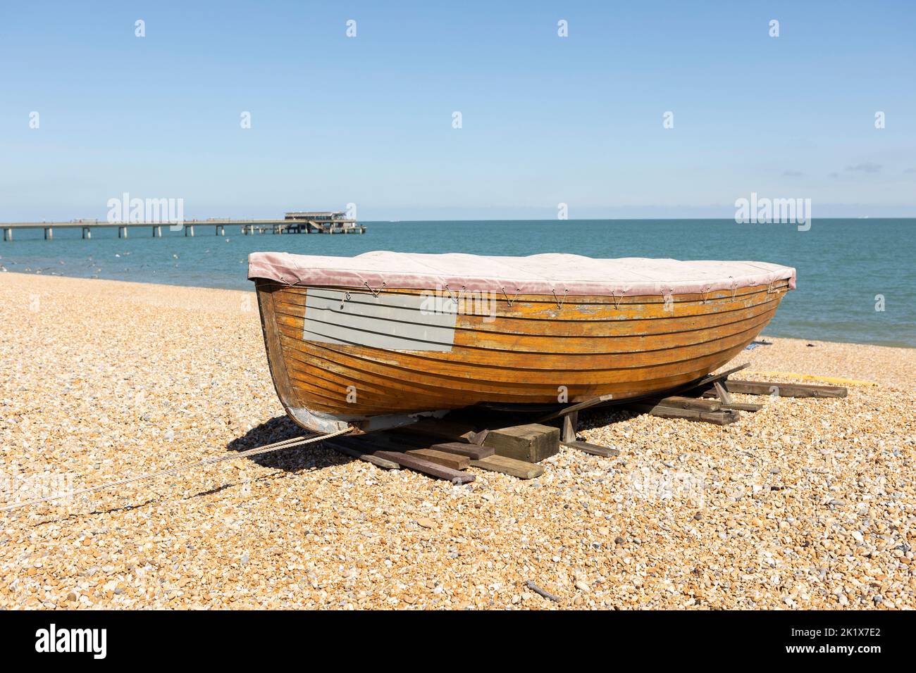old wooden fishing boat moored on a pebble beach Stock Photo - Alamy