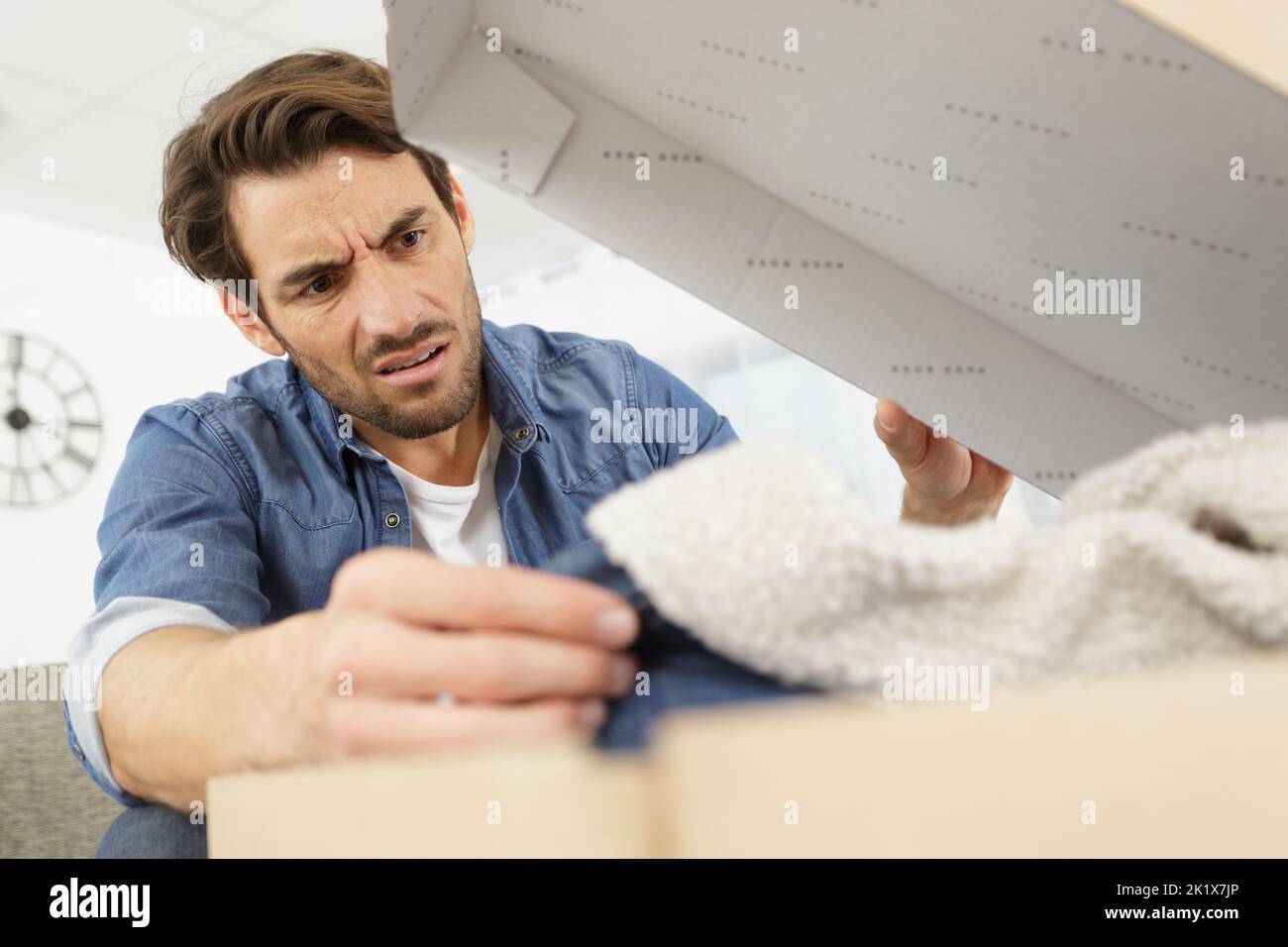 upset man receiving parcel with stolen goods Stock Photo - Alamy