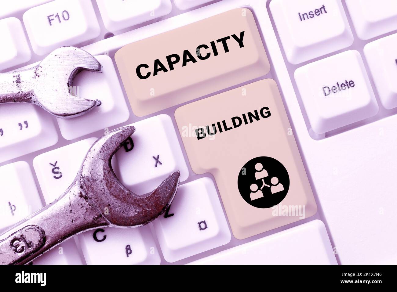 Hand writing sign Capacity BuildingStrengthen the abilities of ...