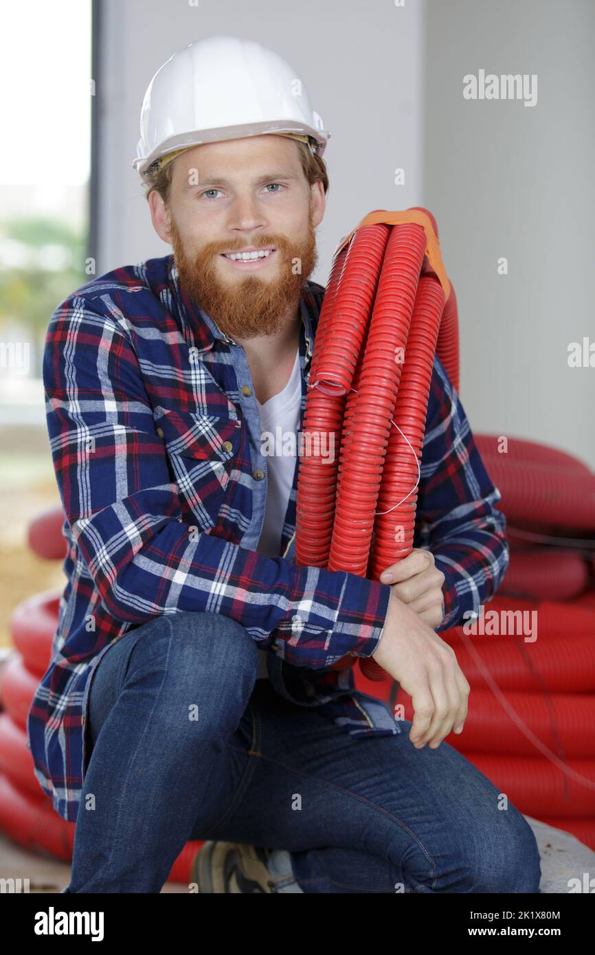portrait of a builder with pipes Stock Photo - Alamy