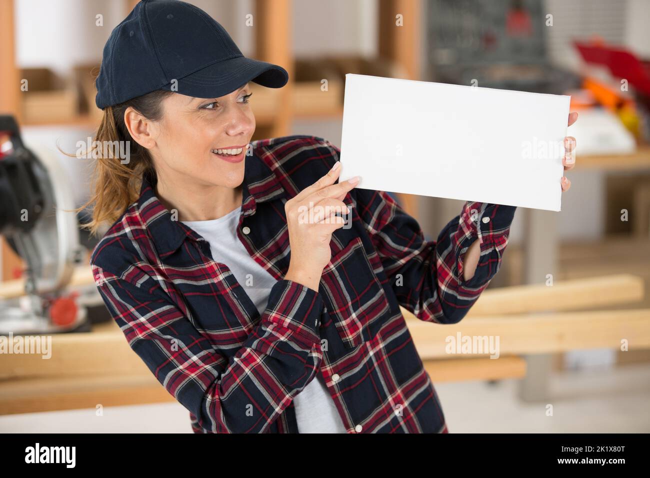 Female builder holding poster hi-res stock photography and images - Alamy