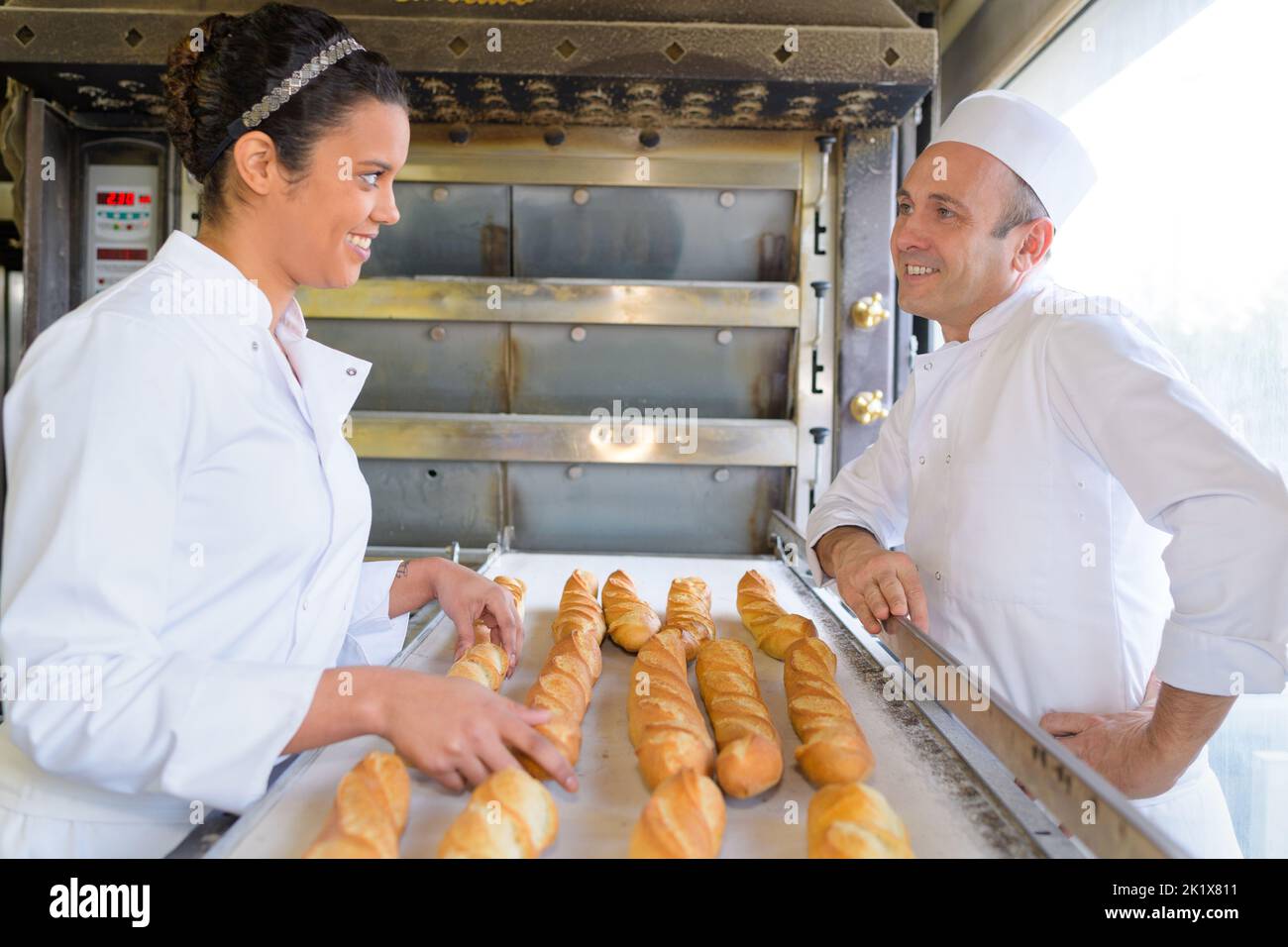 team of bakers smiling in the kitchen of the bakery Stock Photo - Alamy