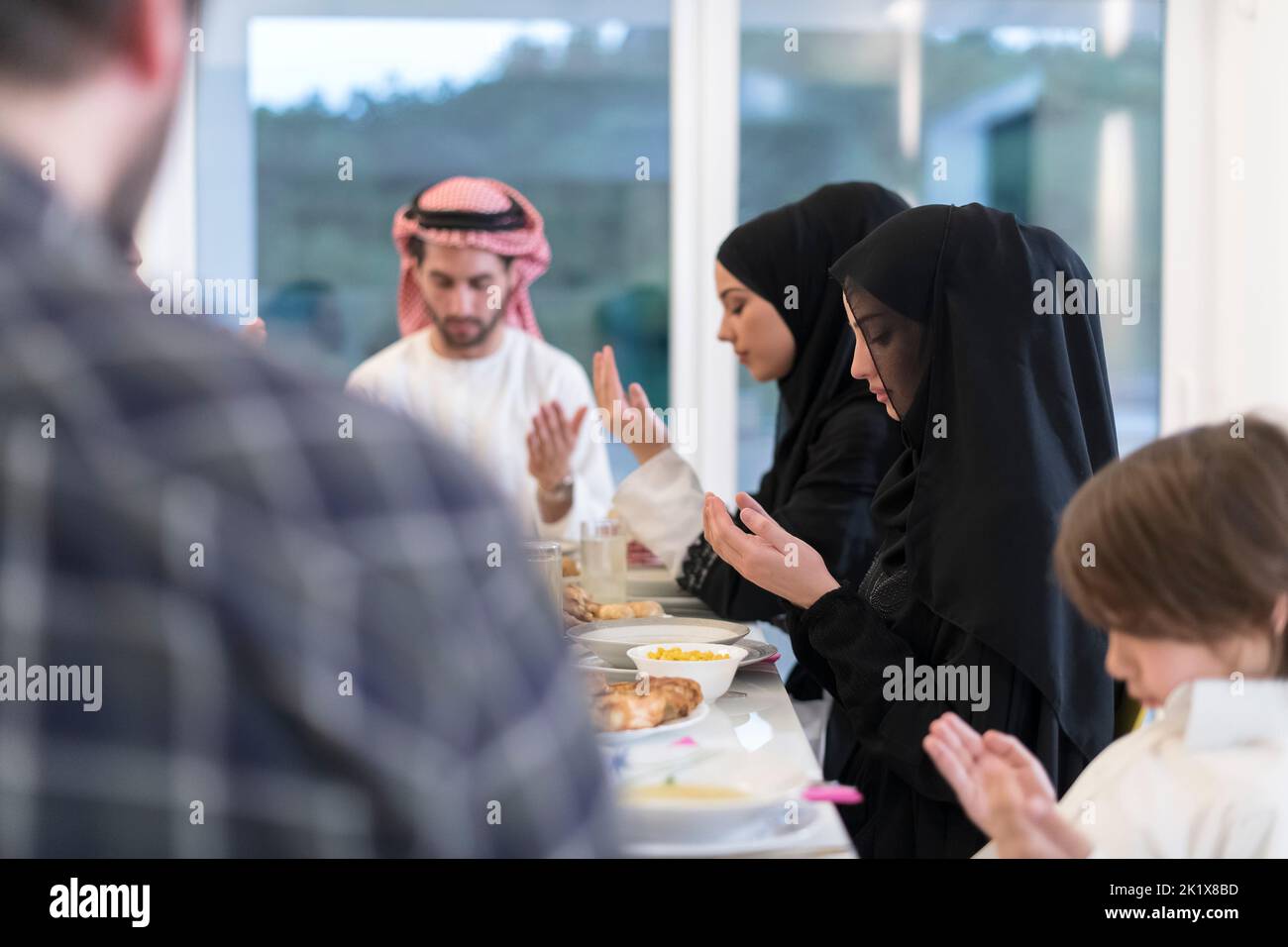 Muslim family making iftar dua to break fasting during Ramadan Stock ...