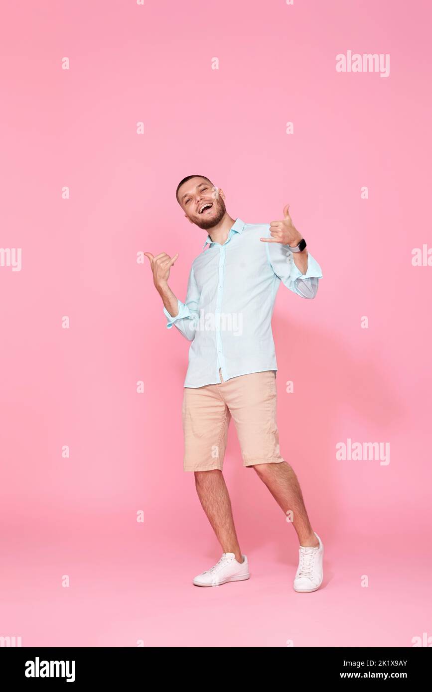 cheerful young happy man dance on pink background Stock Photo - Alamy