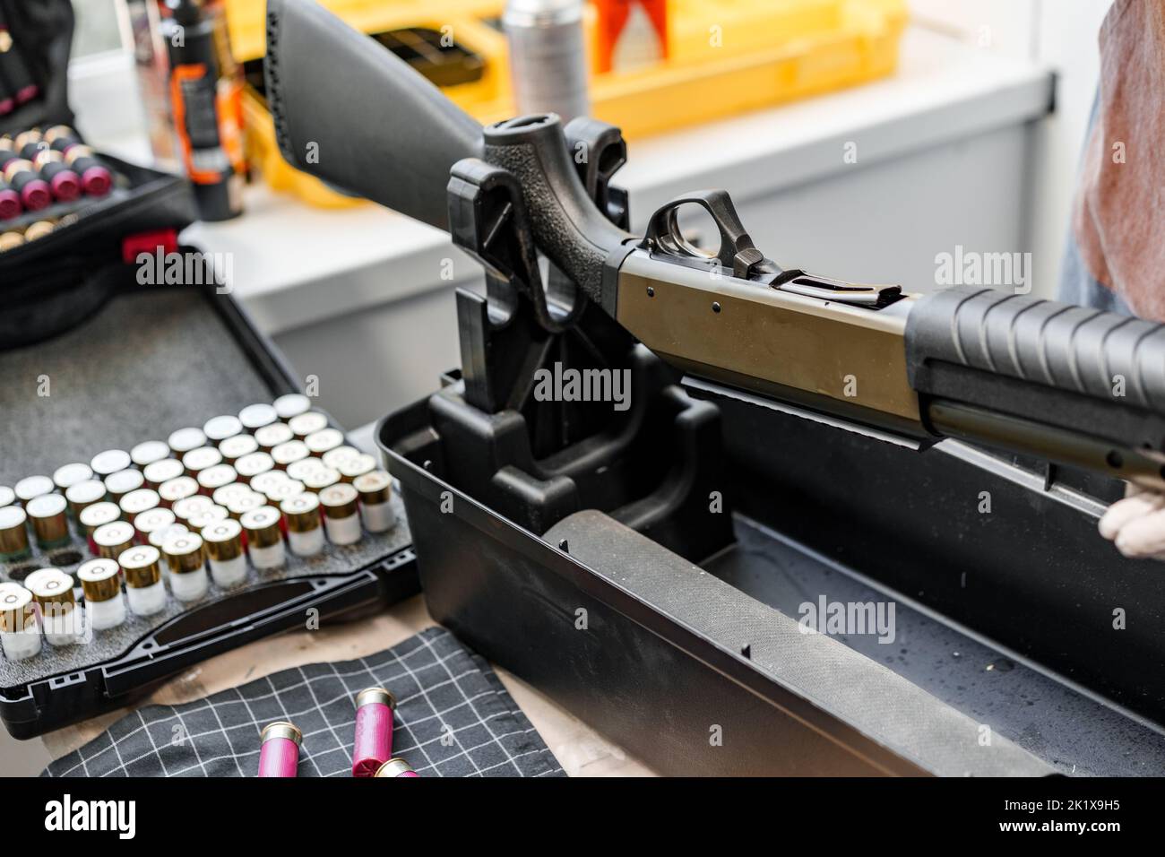 Shotgun rifle with cartridges on table in a weapon workshop Stock Photo ...