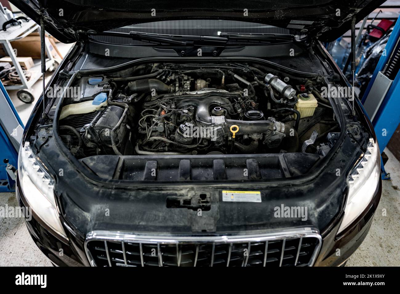 View of engine and other parts under the open hood of a car Stock Photo ...