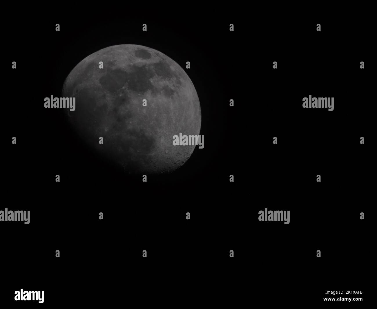 A closeup of the half moon shining in a dark night sky Stock Photo - Alamy