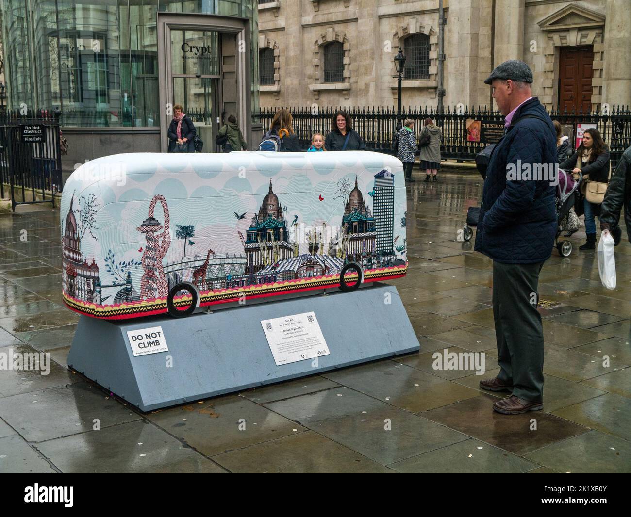 A visitor to London's Trafalgar Square looks at the London Skyline Bus ...