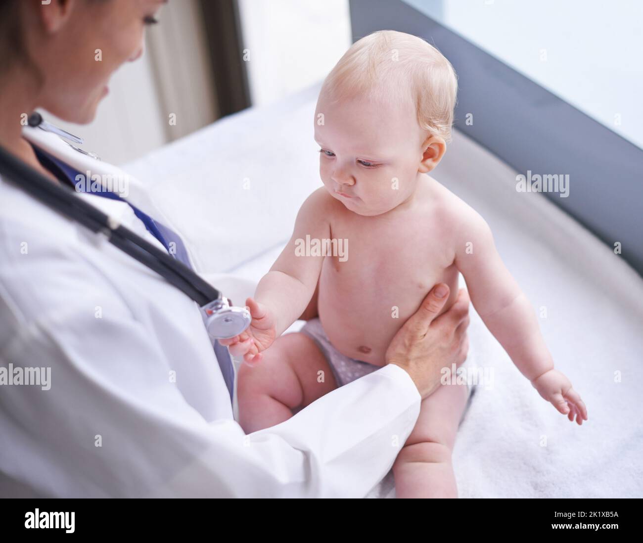 Having his very first checkup. a female doctor doing a checkup of a ...