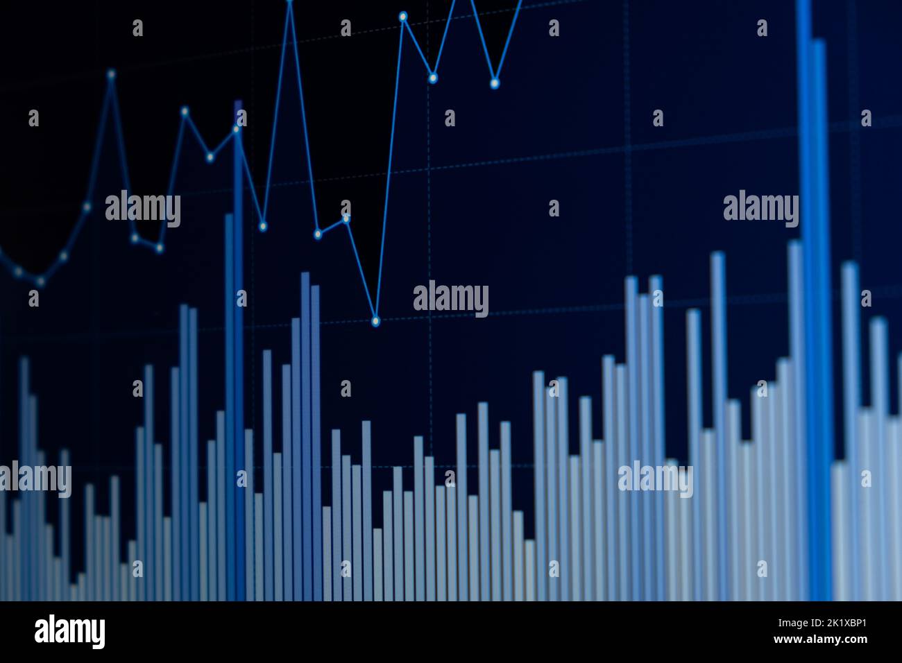 Line chart and bar chart. Close up of a blue chart on a dark background ...