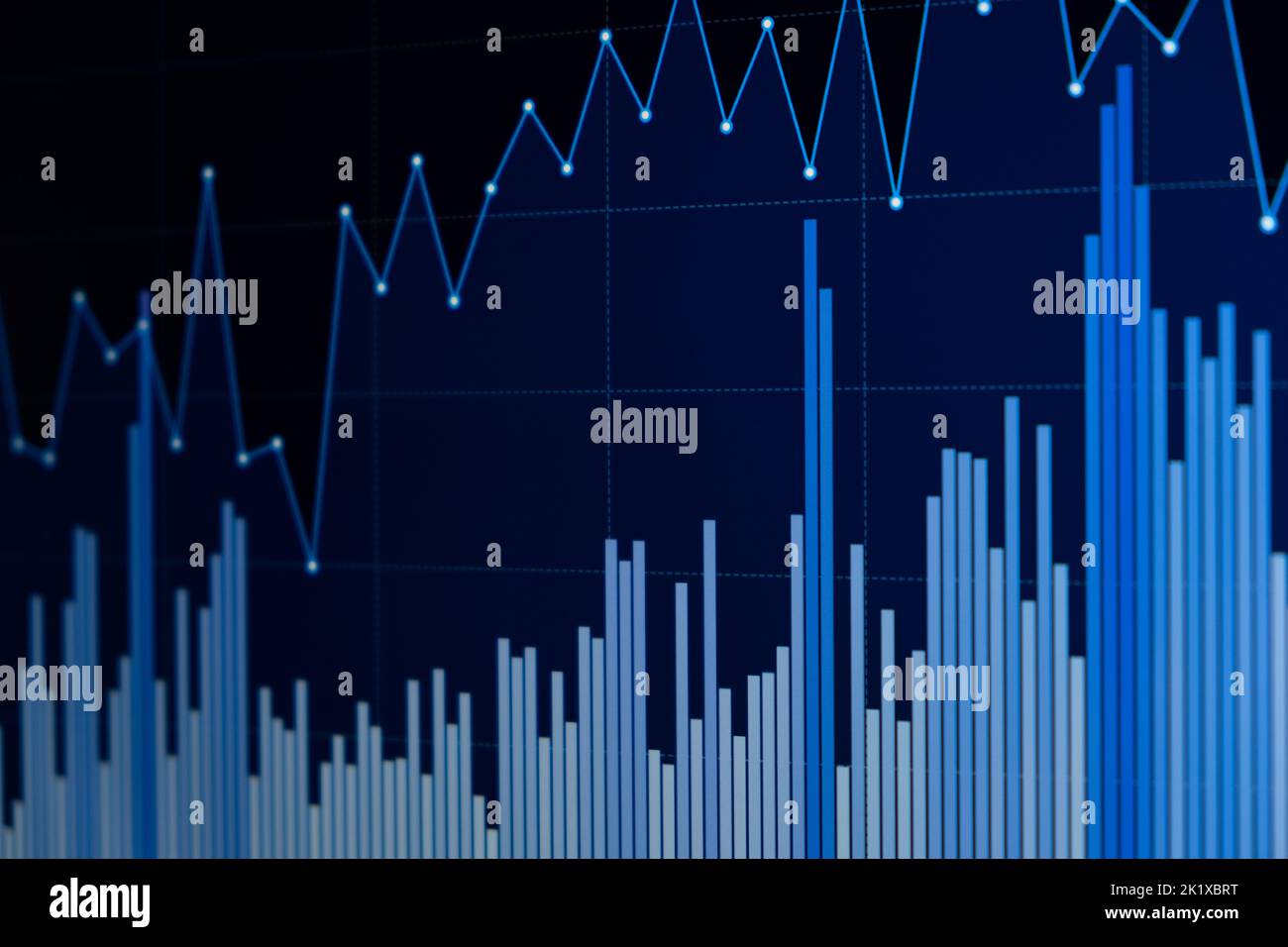 Line chart and bar chart. Close up of a blue chart on a dark background ...