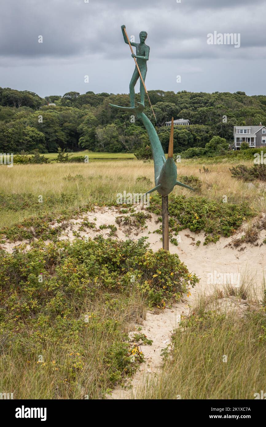 A metal sculpture of a harpooner on the beach Stock Photo - Alamy
