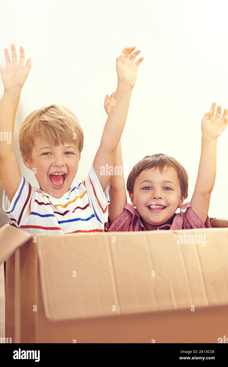 Are you guys ready to ride. Two young brothers raising their arms as ...