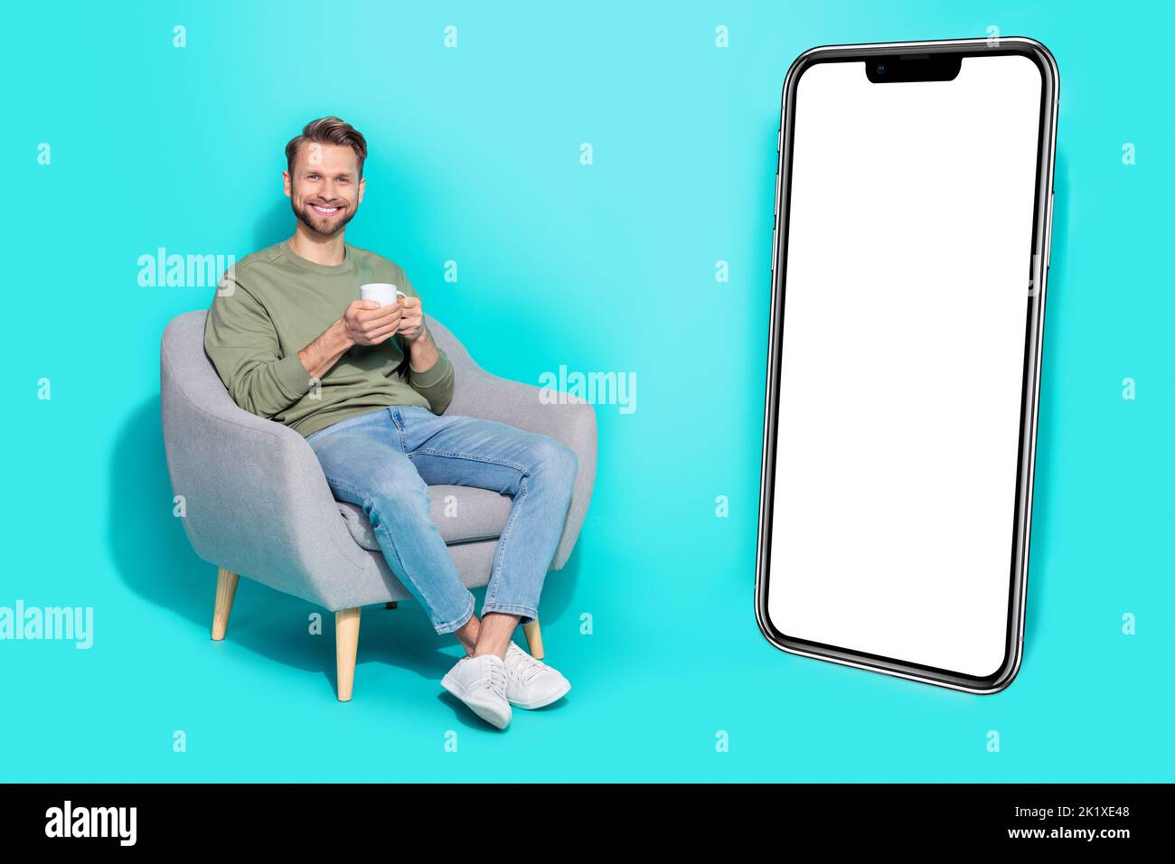 Photo of cheerful relaxed man sit armchair hold cup drink coffee empty ...