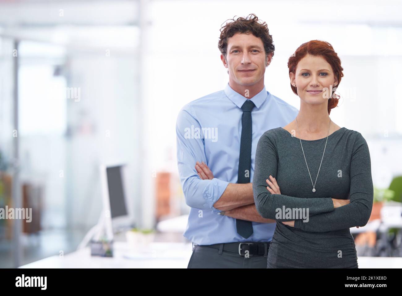 Success is their priority. two colleagues standing in an office Stock ...
