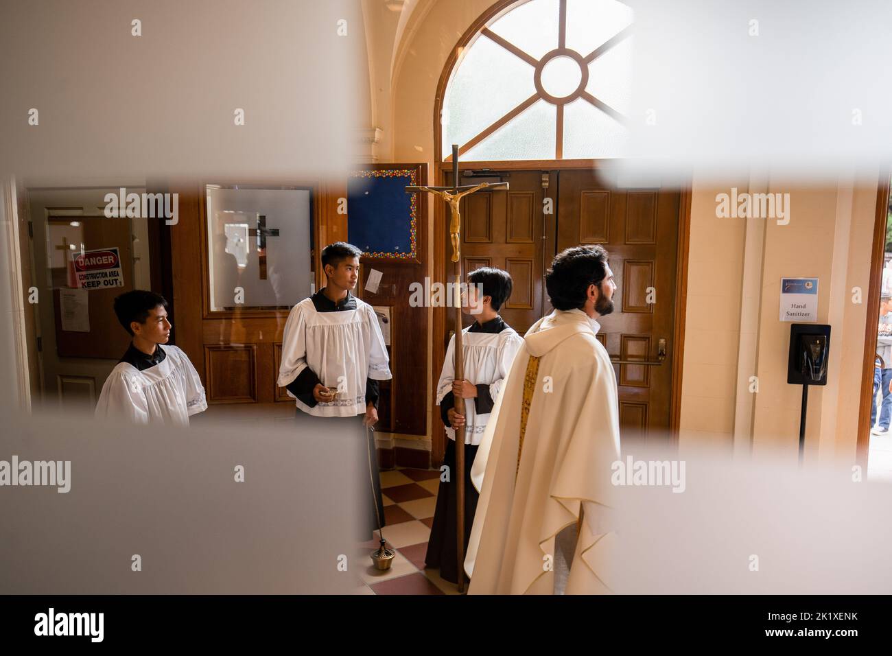 Students and priest prepare for the liturgy at St Joseph Basilica. In ...