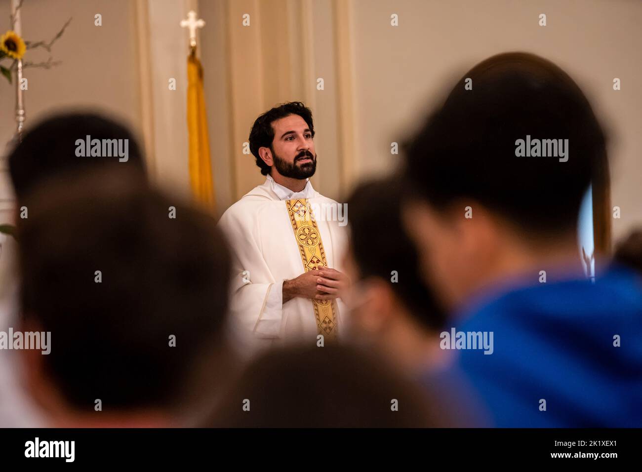 Priest leads students during the liturgy at St Joseph Basilica. In the ...
