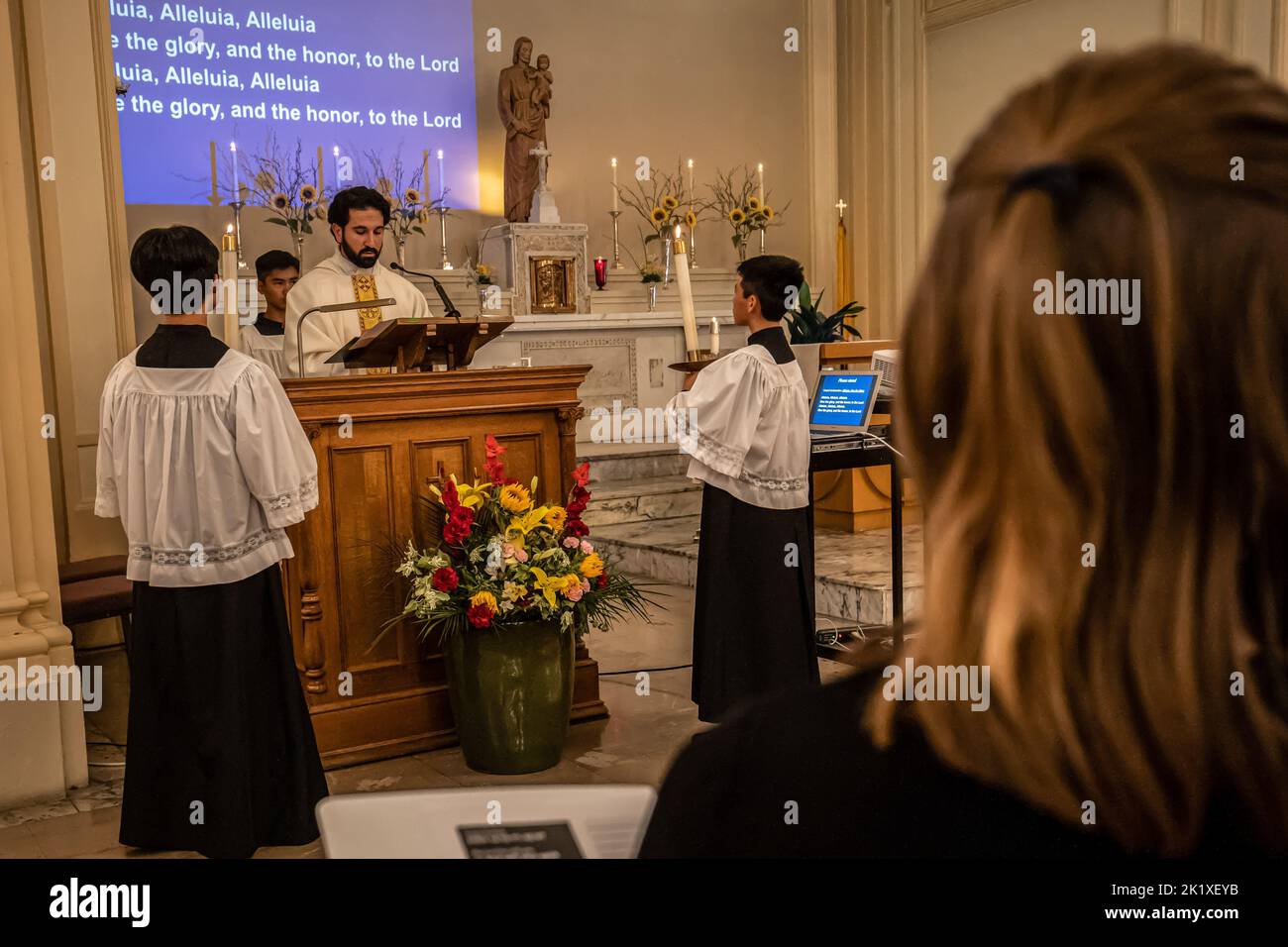 Priest leads students during the liturgy at St Joseph Basilica. In the ...