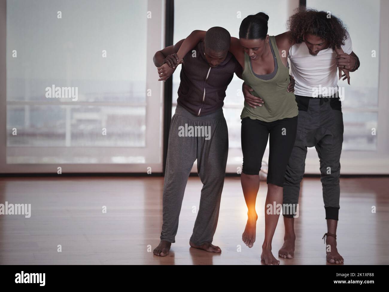 Helping her off the studio floor. a two young dancers helping a friend ...