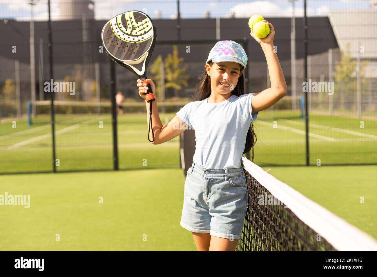 little girl with racket playing padel tennis at court Stock Photo - Alamy