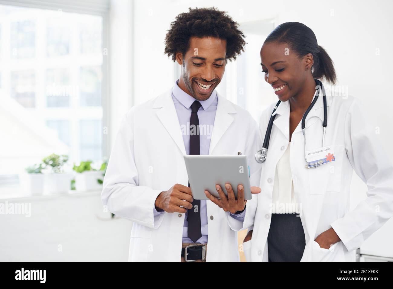 Technology makes medical research a breeze. two doctors standing in a ...