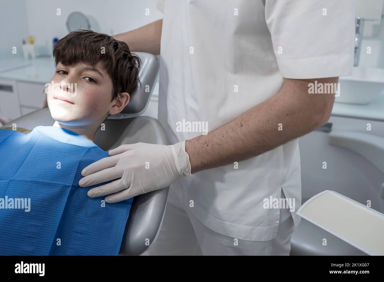 Concept of painless dental treatment. Child sitting in a dental chair ...