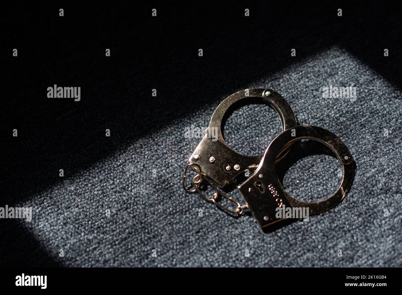 the black handcuffs on wooden background. criminal justice Stock Photo ...