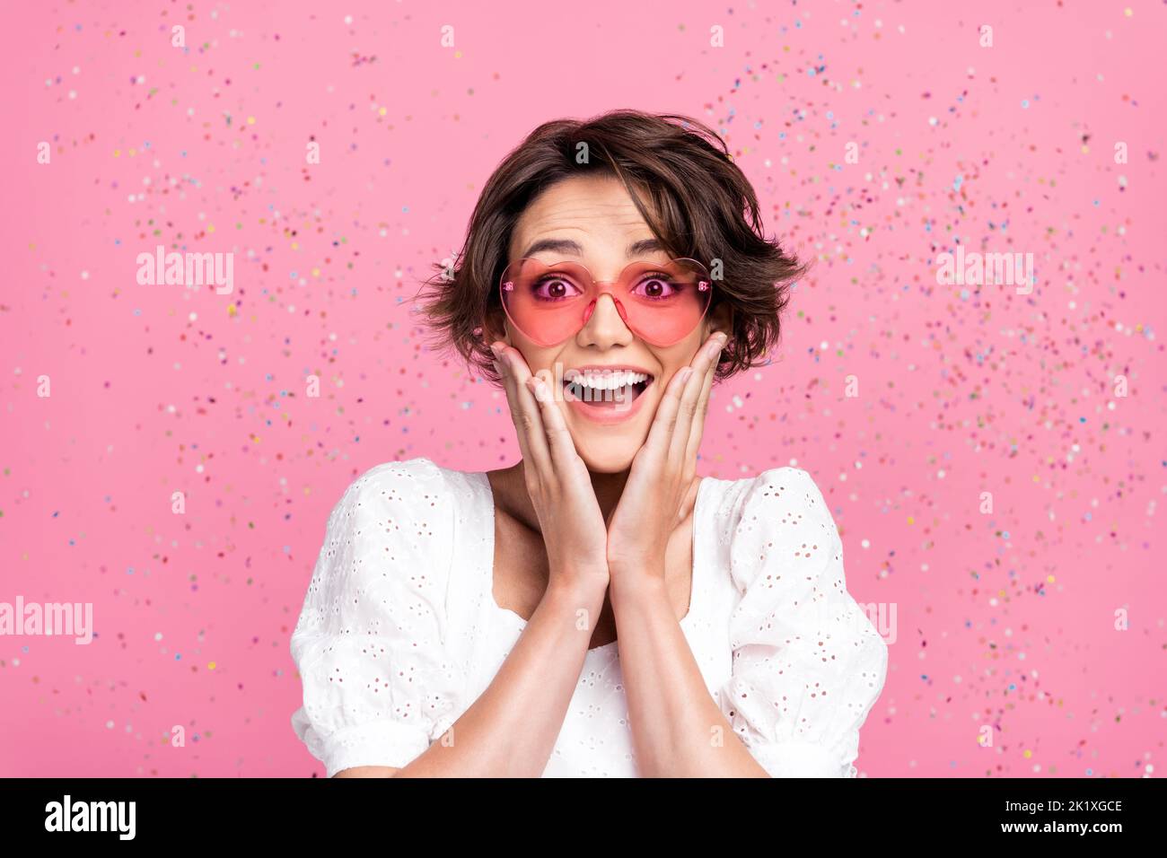 Photo of funny impressed girl dressed white top heart eyewear arms ...