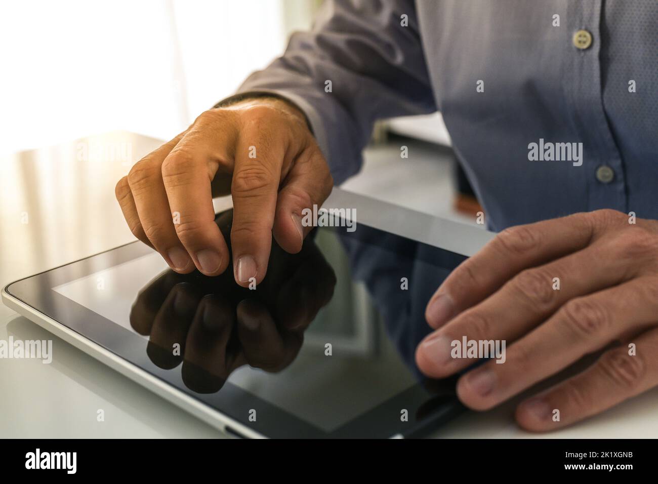 Closeup man hands typing on tablet screen. Businessman using digital ...