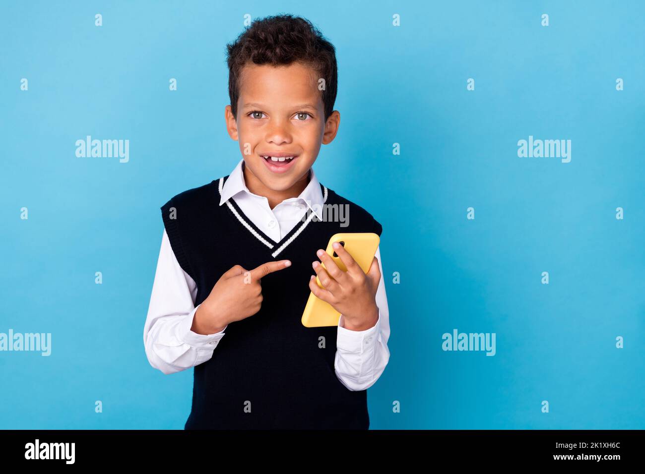 Photo of cheerful schoolkid indicate finger telephone application ...