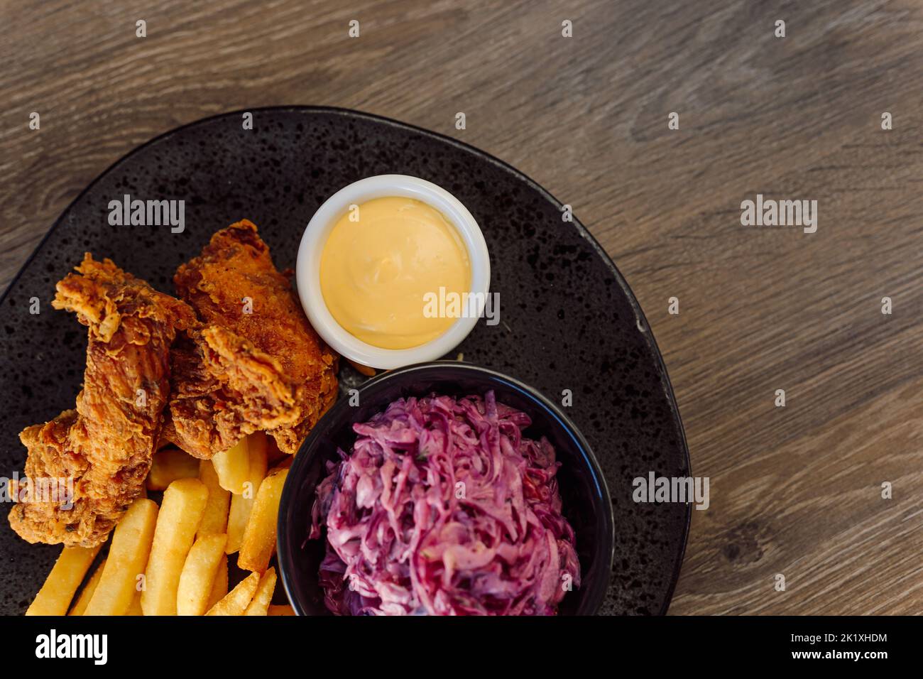 Close up fried, breaded chicken meat, gold strips with beet root salad ...