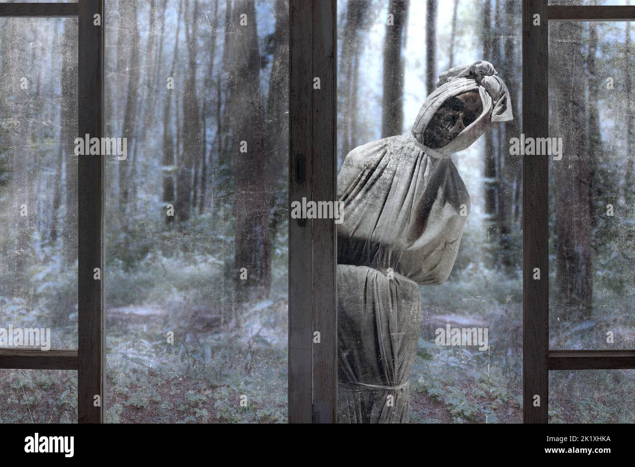 Pocong is covered with a white linen shroud standing outside an ...