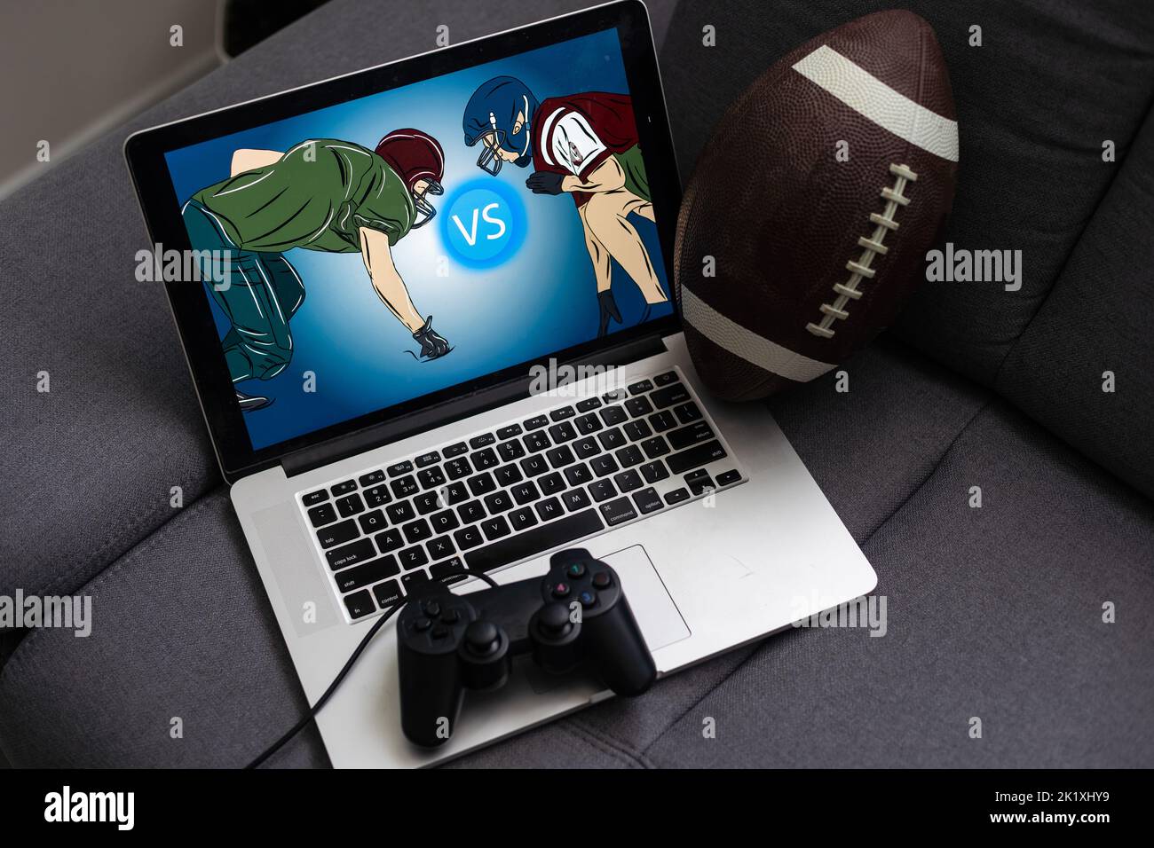 American football ball and joystick. video game Stock Photo - Alamy